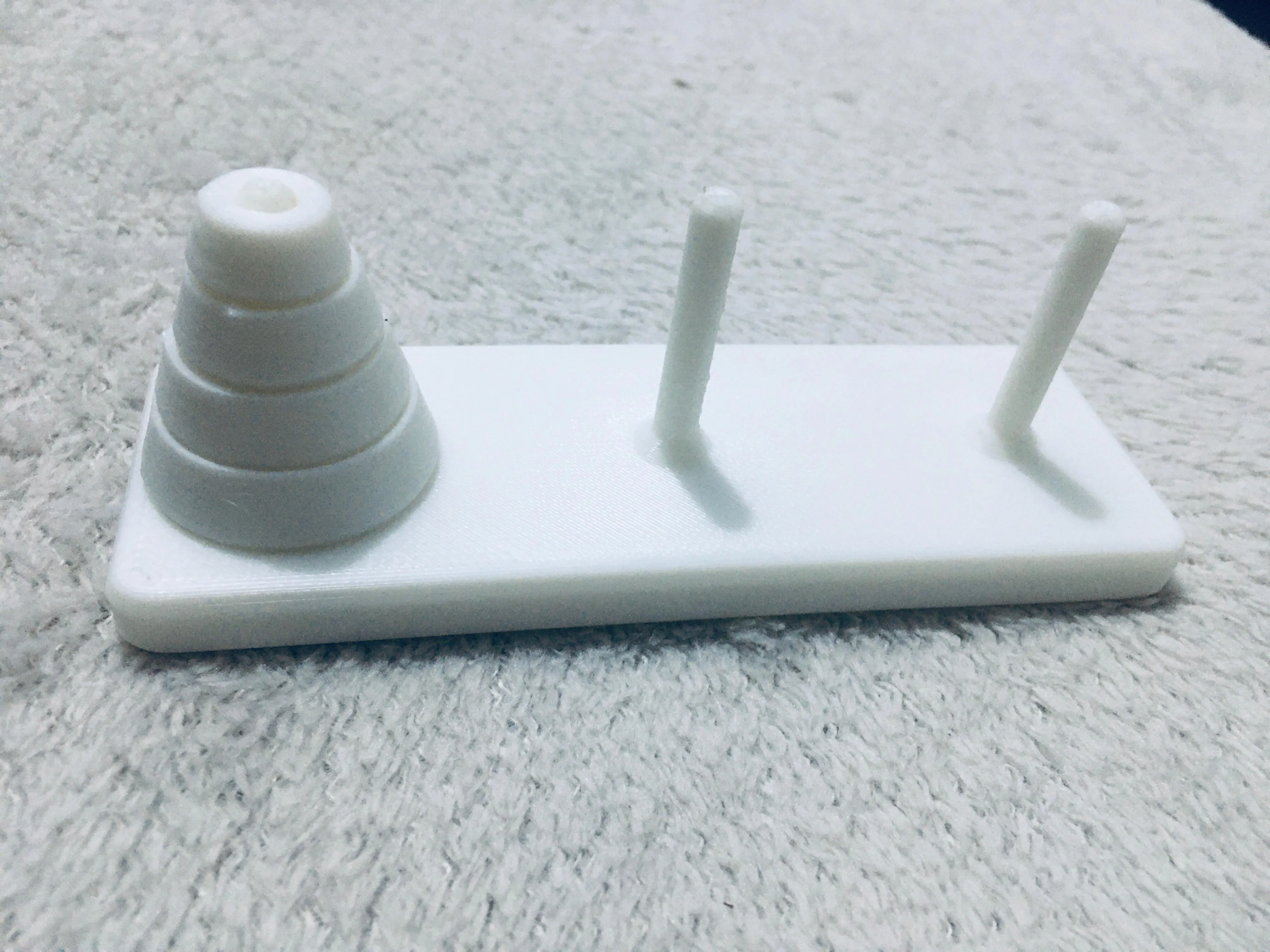 Three rods and 4 disks of varying sizes that may be slid onto any rod ...