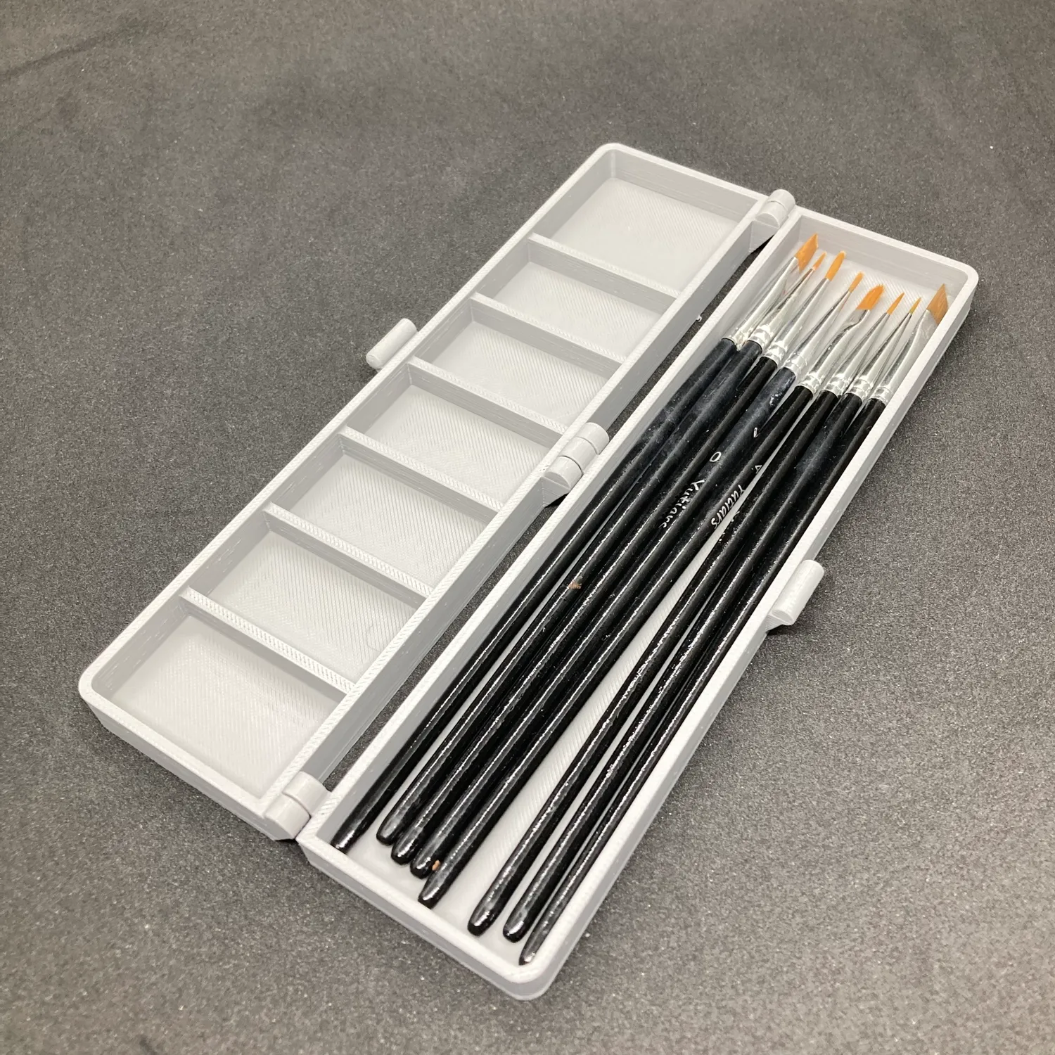A clean and functional storage box designed to keep your art brushes ...