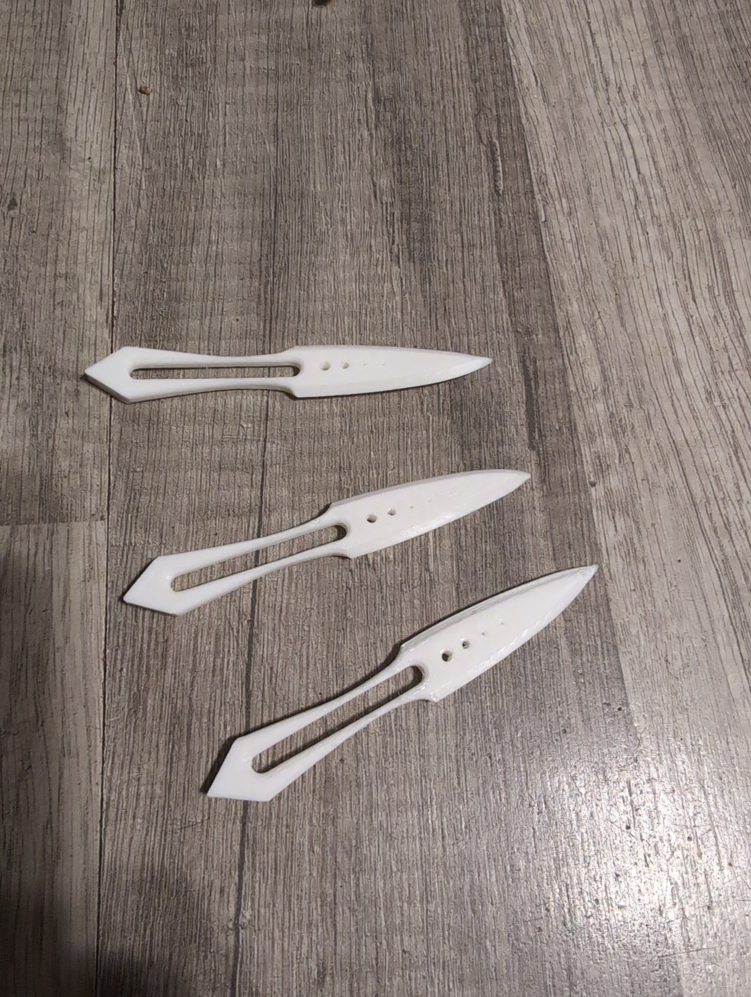 miniature throwing knives. they're about the size of my finger. turned ...