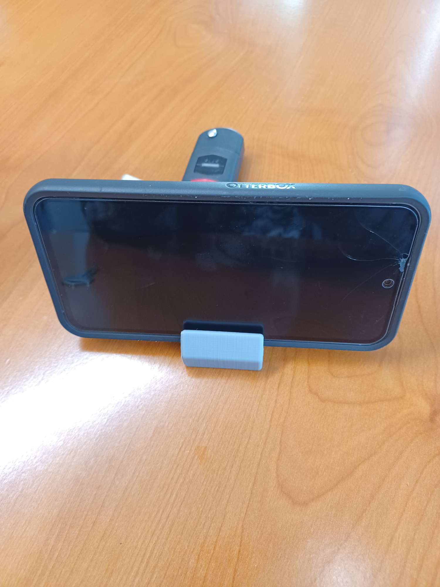 The first print didn't take into account the cellphone's case, so it ...